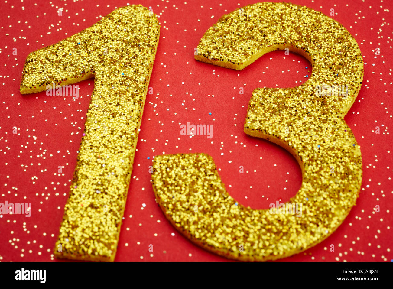 Number thirteen yellow color over a red background. Anniversary ...