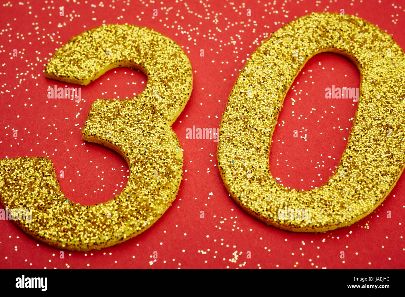 Number thirty yellow color over a red background. Anniversary ...