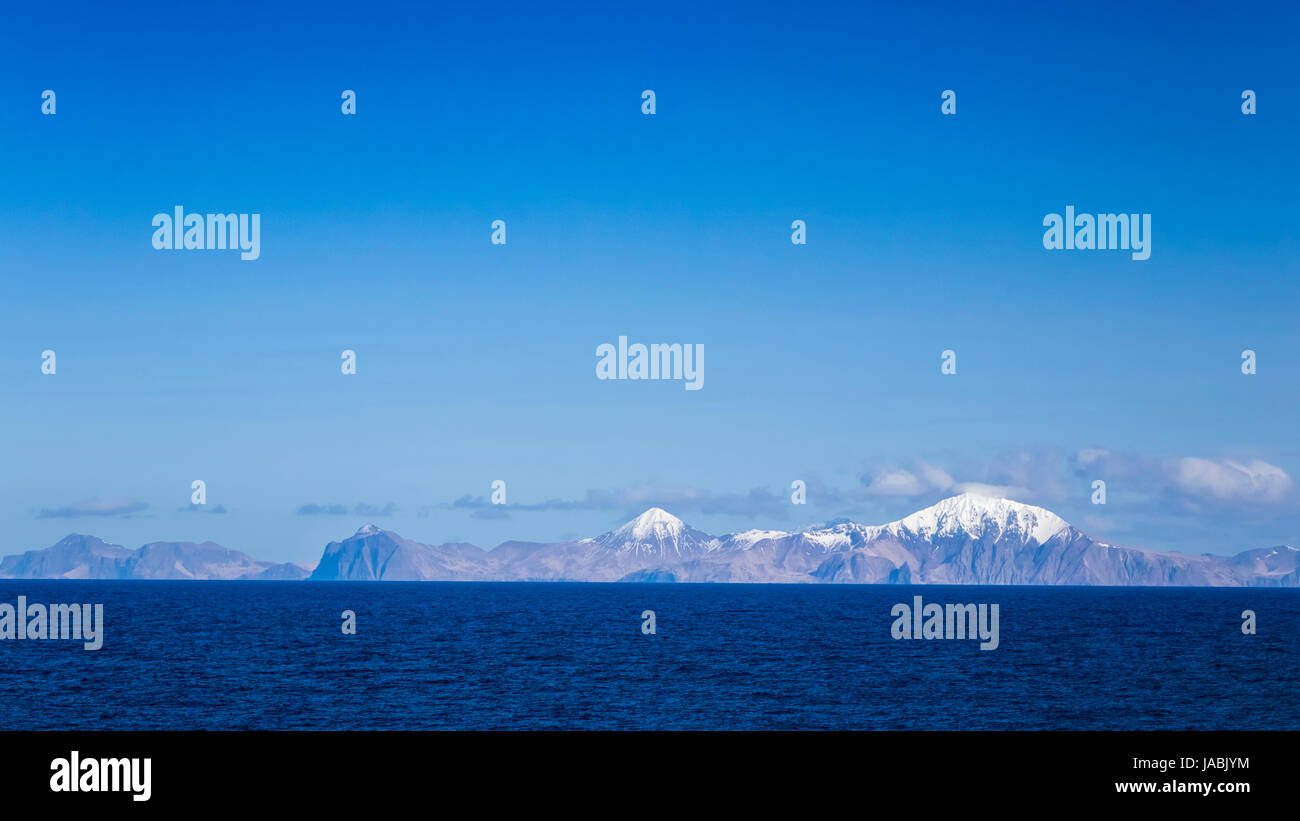 A chain of snow capped mountains in the Aleutian Islands near Unimak ...