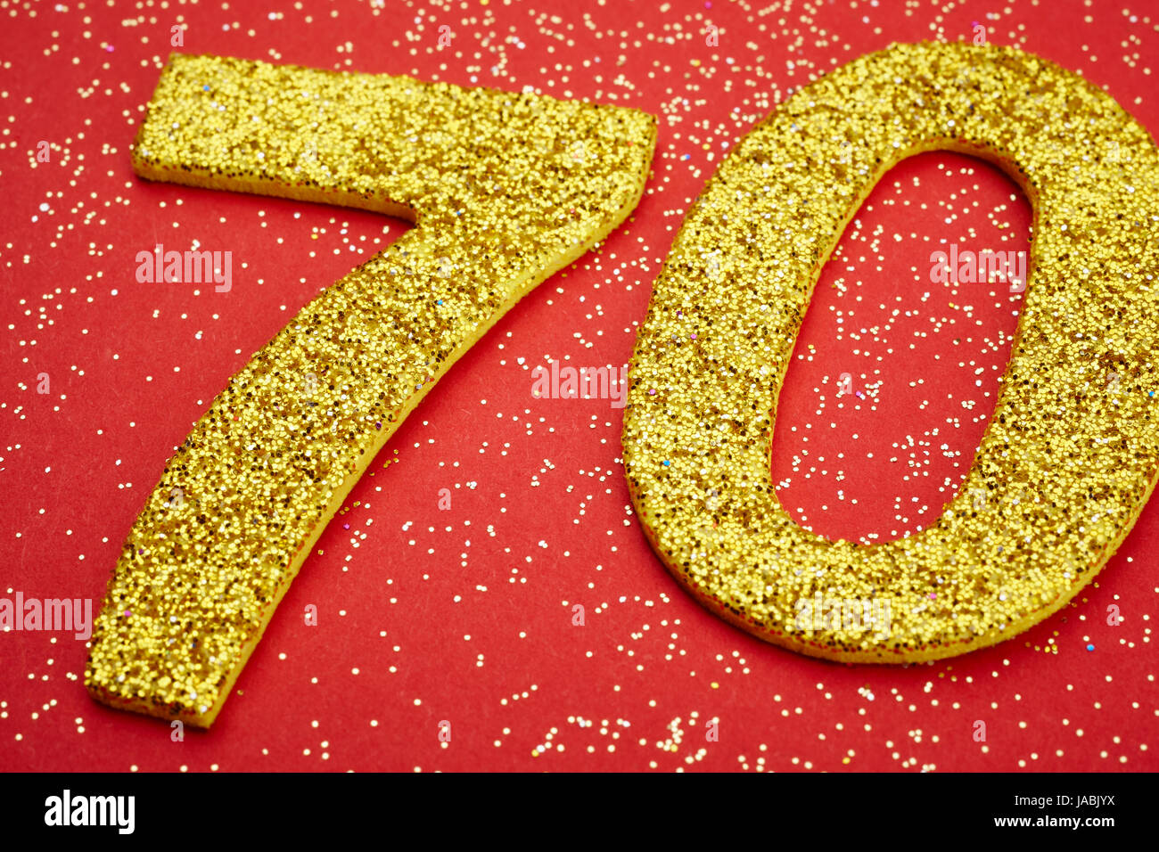Number seventy golden color over a red background. Anniversary ...