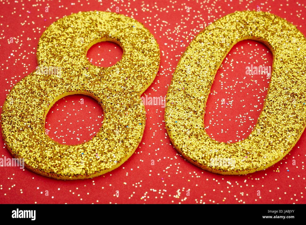 Number eighty golden color over a red background. Anniversary ...