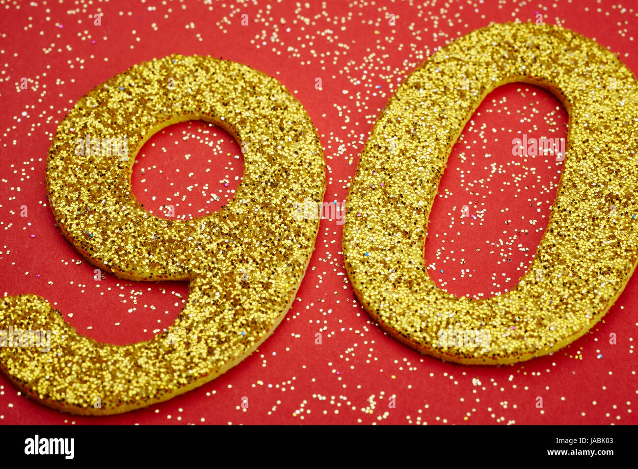 Number ninety golden color over a red background. Anniversary ...