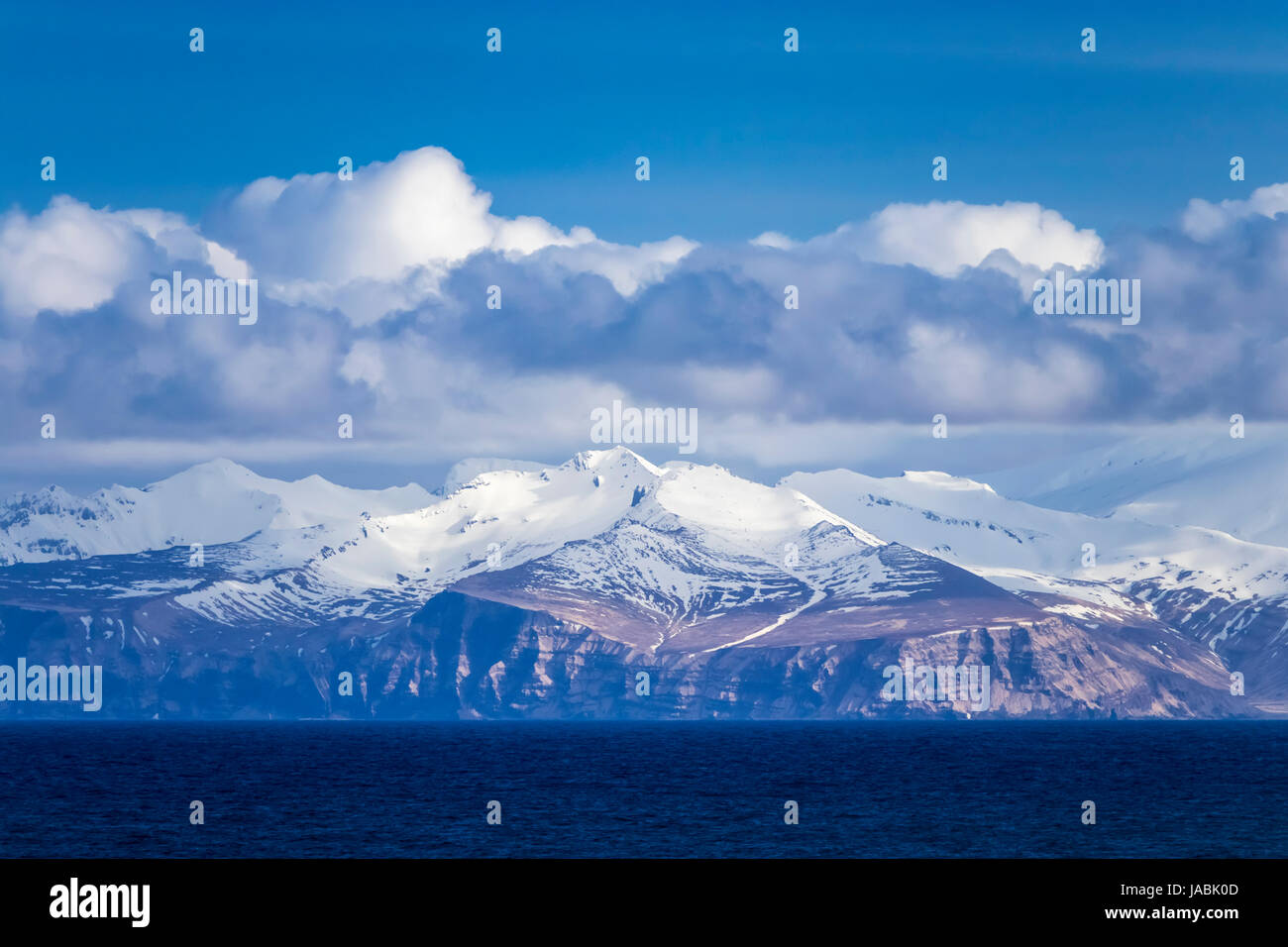 A chain of snow capped mountains in the Aleutian Islands near Unimak ...