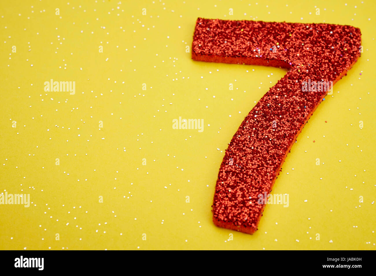 Number seven red color over a yellow background. Anniversary ...