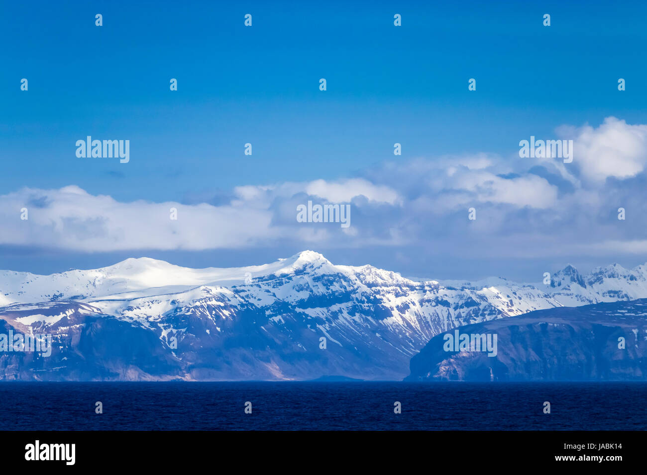 A chain of snow capped mountains in the Aleutian Islands near Unimak ...