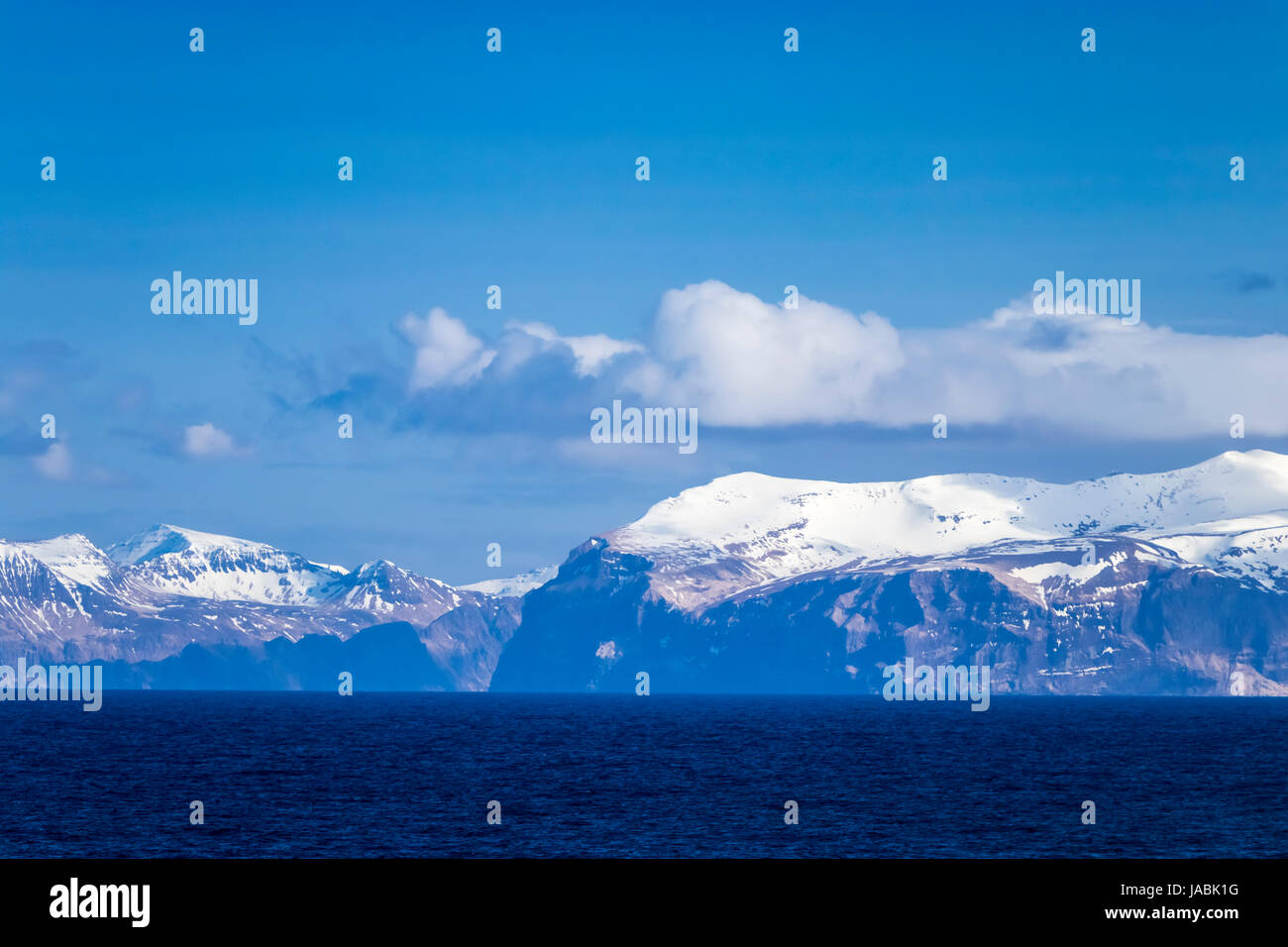 A chain of snow capped mountains in the Aleutian Islands near Unimak ...