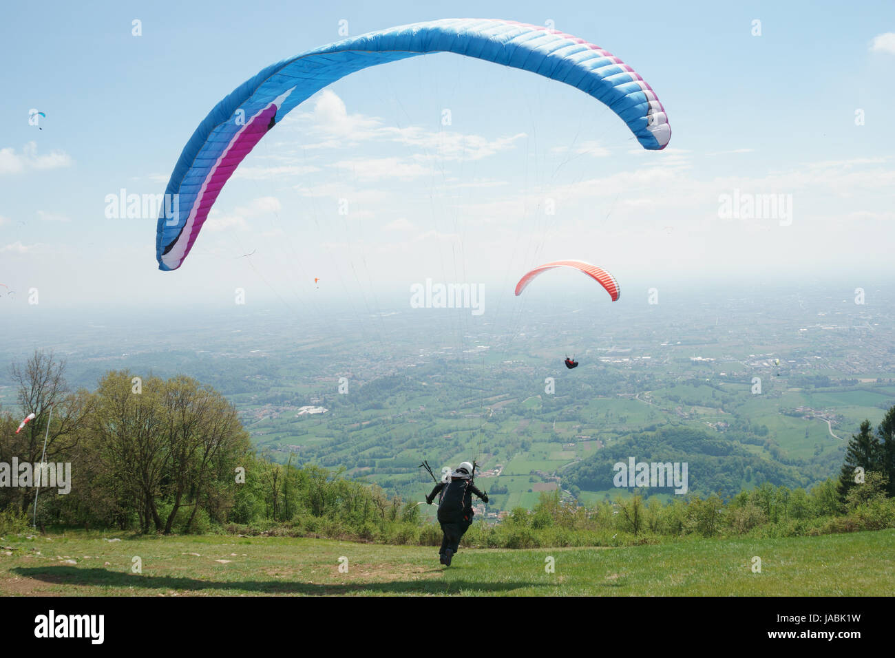 Paragliders taking off from mountain Stock Photo - Alamy