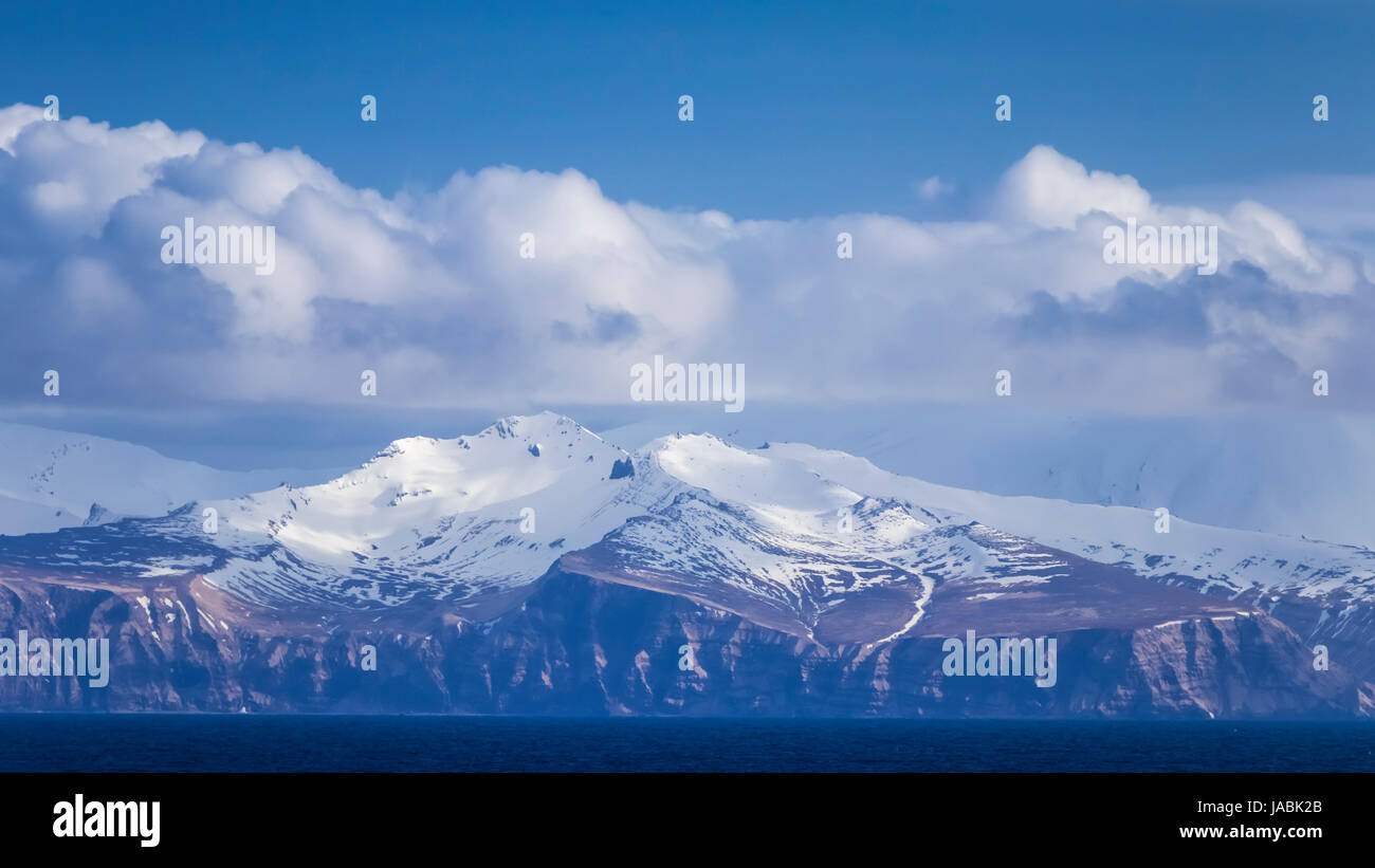 A chain of snow capped mountains in the Aleutian Islands near Unimak ...