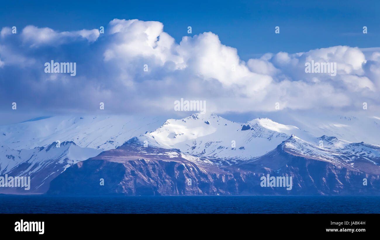 A chain of snow capped mountains in the Aleutian Islands near Unimak ...