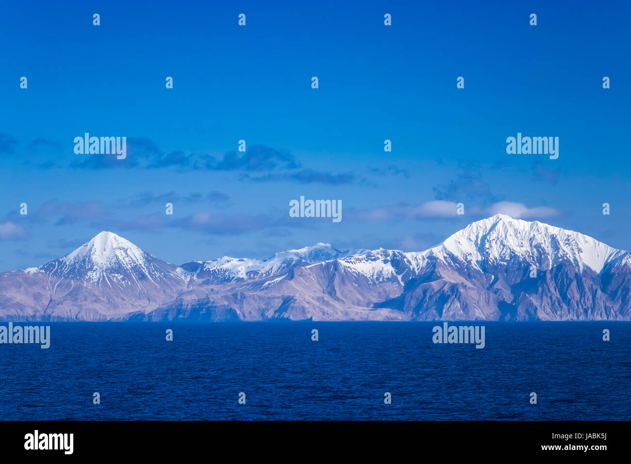 A chain of snow capped mountains in the Aleutian Islands near Unimak ...