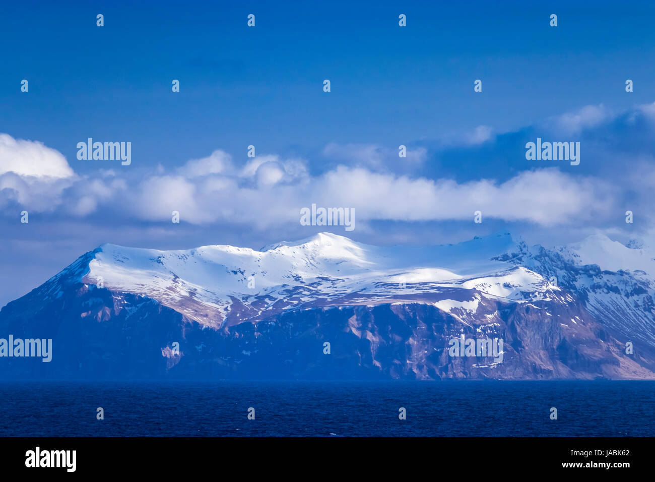 A chain of snow capped mountains in the Aleutian Islands near Unimak ...