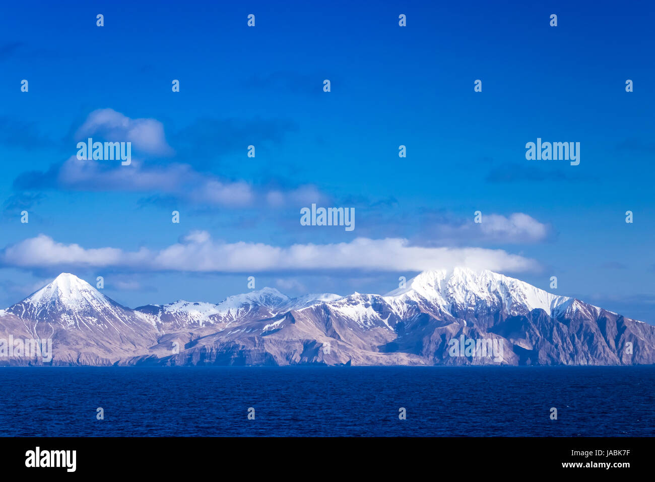 A chain of snow capped mountains in the Aleutian Islands near Unimak ...