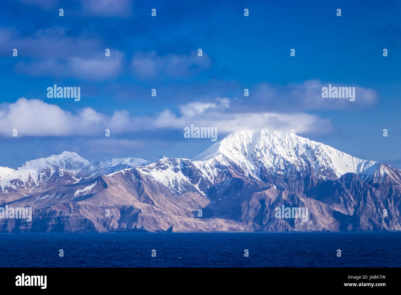 A chain of snow capped mountains in the Aleutian Islands near Unimak ...