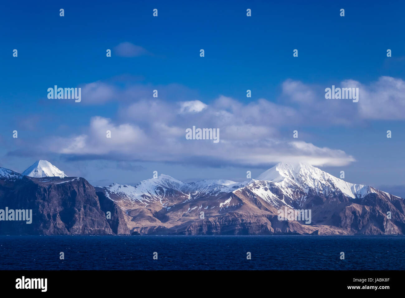 A chain of snow capped mountains in the Aleutian Islands near Unimak ...