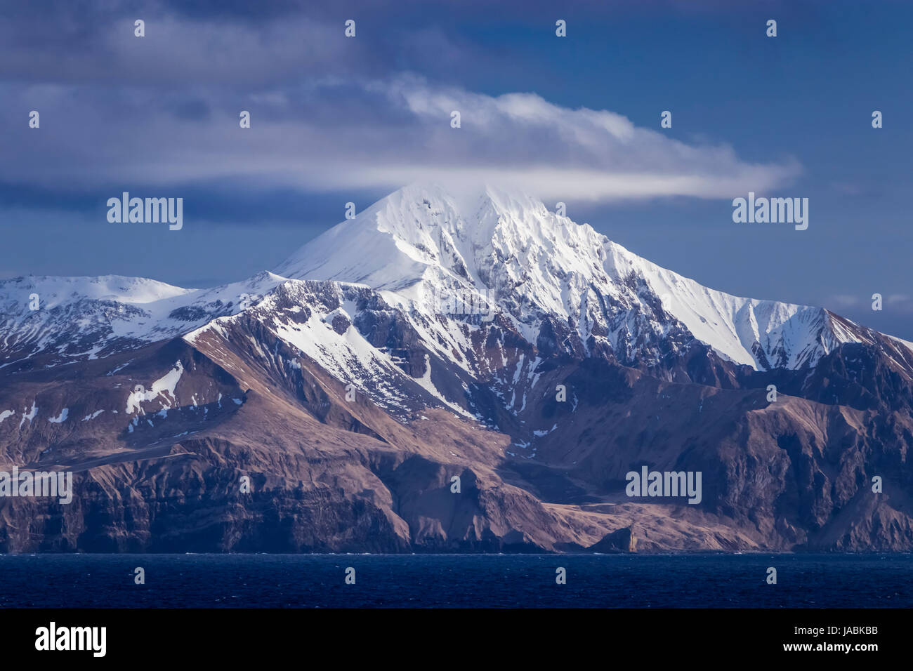 A chain of snow capped mountains in the Aleutian Islands near Unimak ...