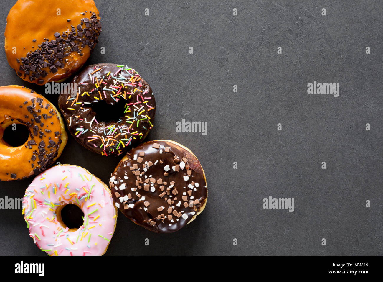 Glazed donuts on dark background. Table top view and copy space Stock ...