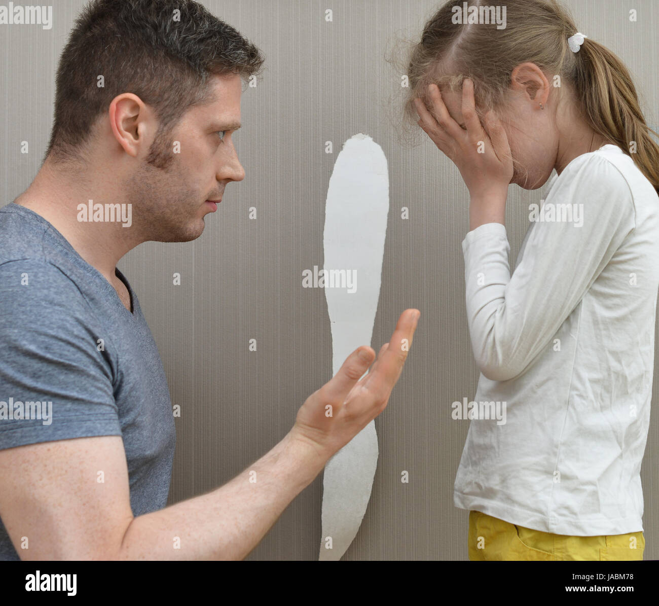 Little girl spoiled the wallpaper and her dad is angry Stock Photo - Alamy