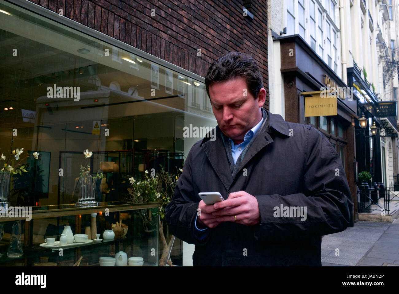 Man checking his smartphone Stock Photo - Alamy