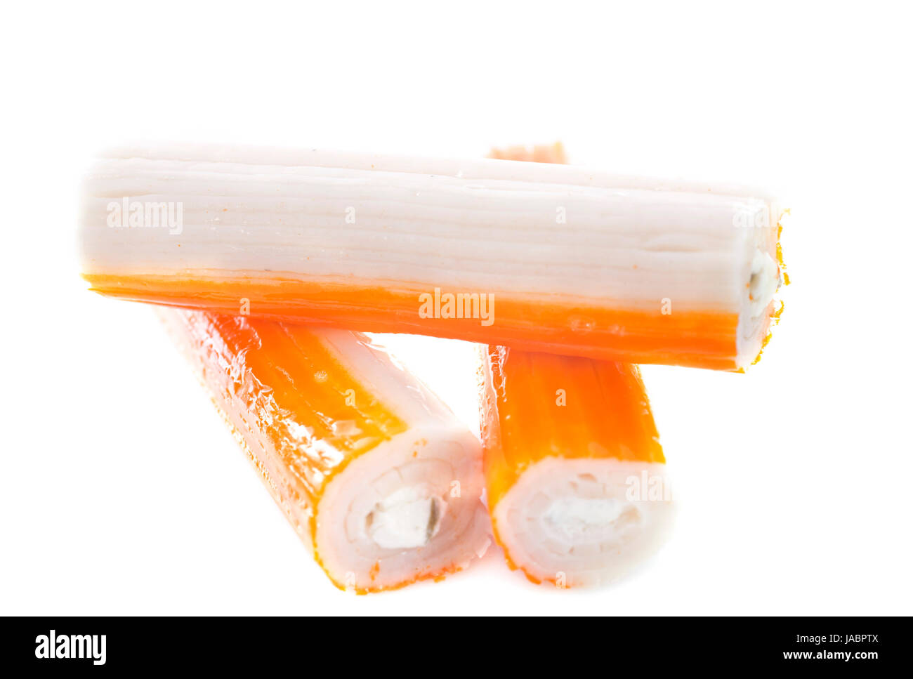 sticks of surimi in front of white background Stock Photo - Alamy