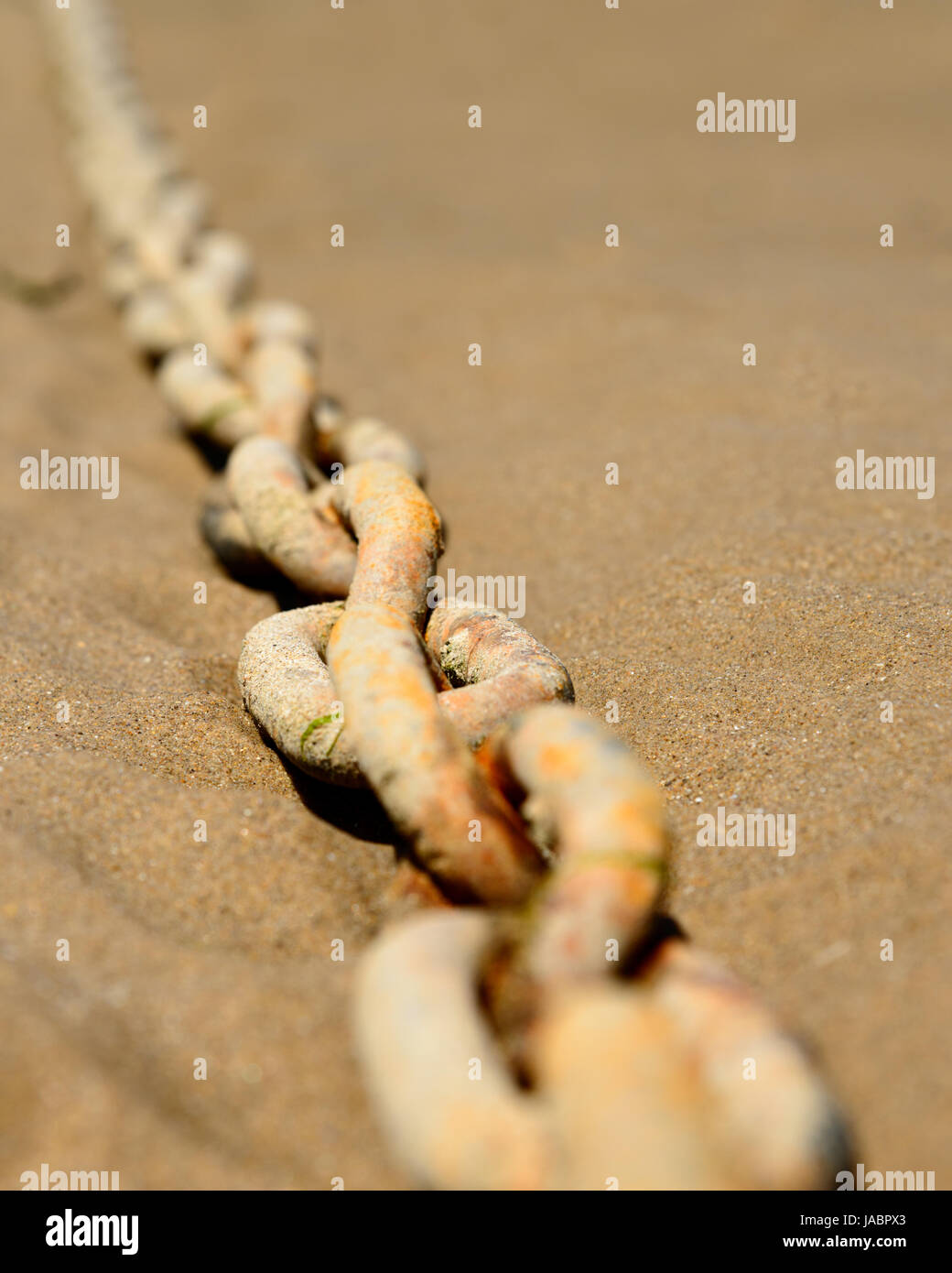 Link chain showing signs of corrosion in harbour sands at low tide ...