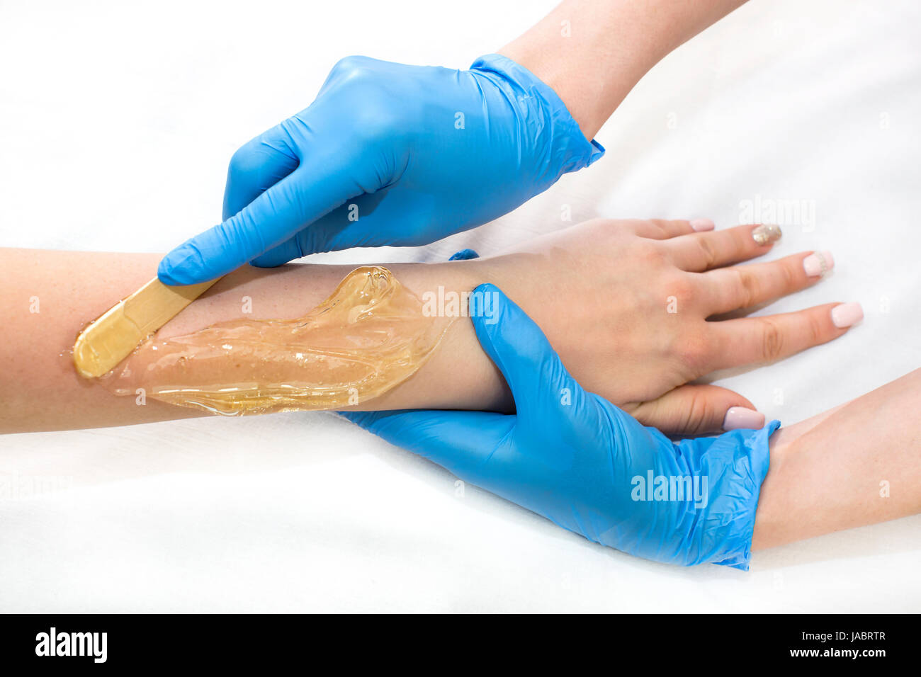 Epilation sugar processes woman passes in a beauty salon Stock Photo ...