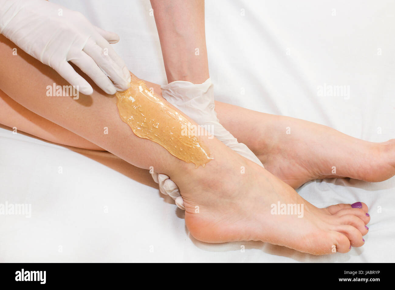 Epilation sugar processes woman passes in a beauty salon Stock Photo ...