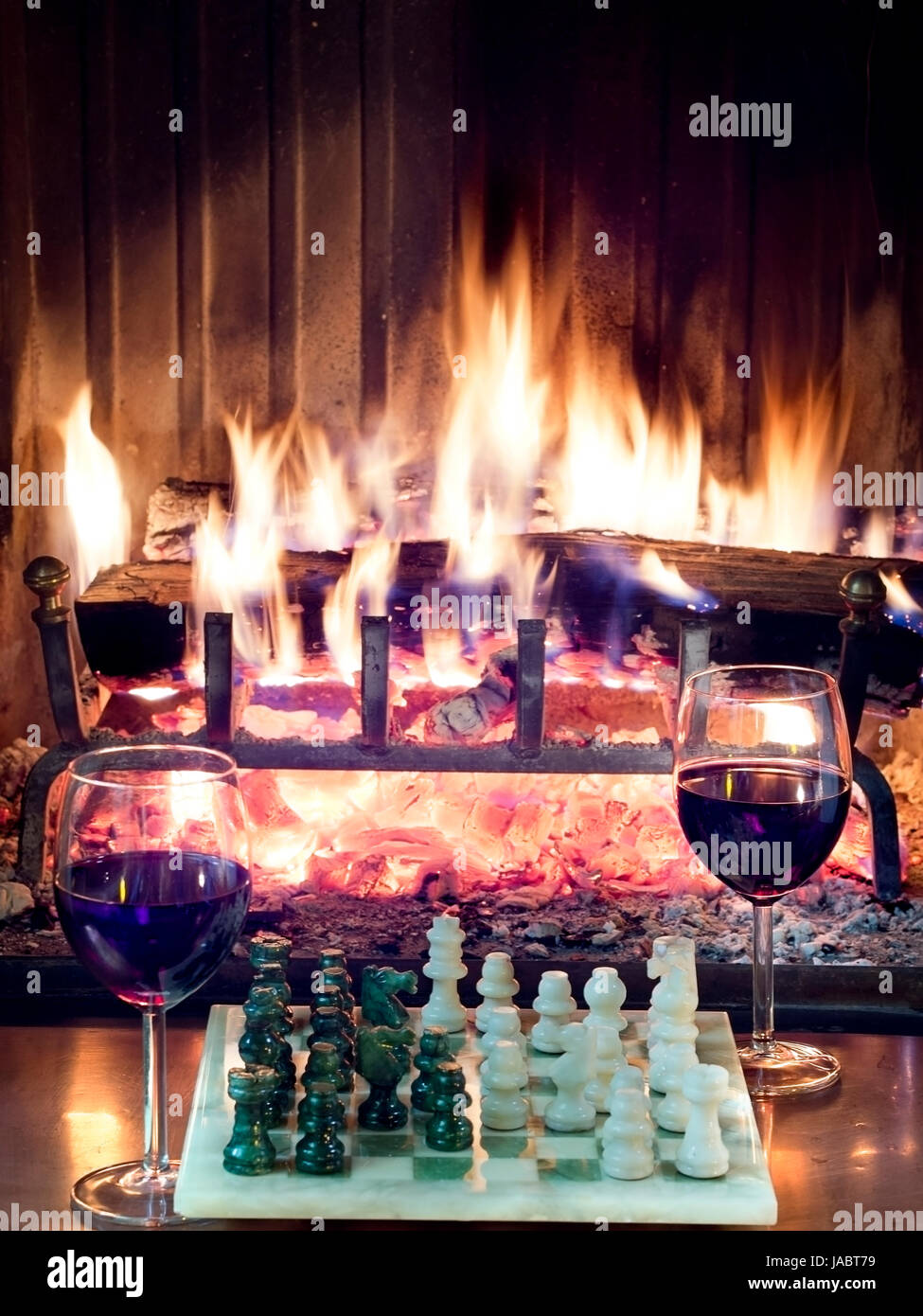 play chess drinking red wine in front of a roaring fireplace Stock ...