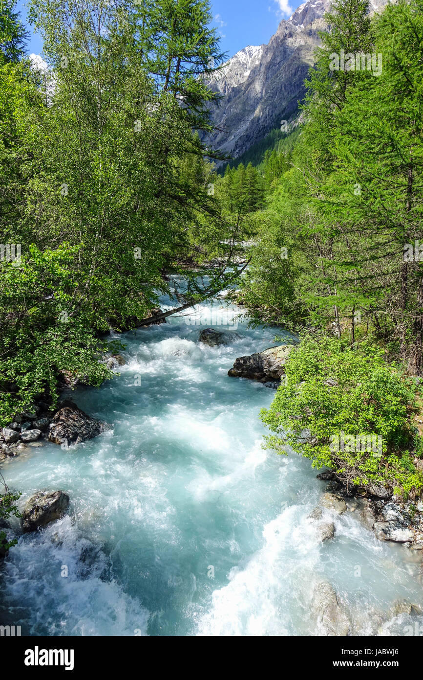 River in flood with melting snow, end of winter, Briancon, French Alps ...