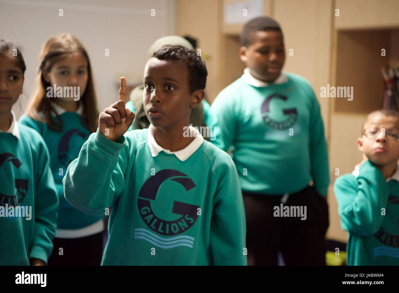 Primary pupil asking a question Stock Photo - Alamy