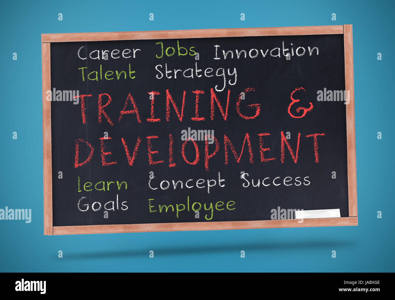 Training and development terms written on a chalkboard against blue ...