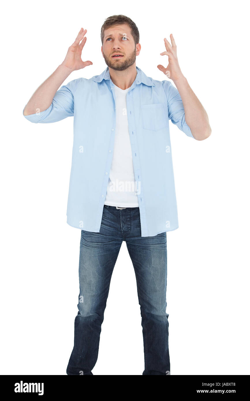 Reproachful man looking up on white background Stock Photo - Alamy