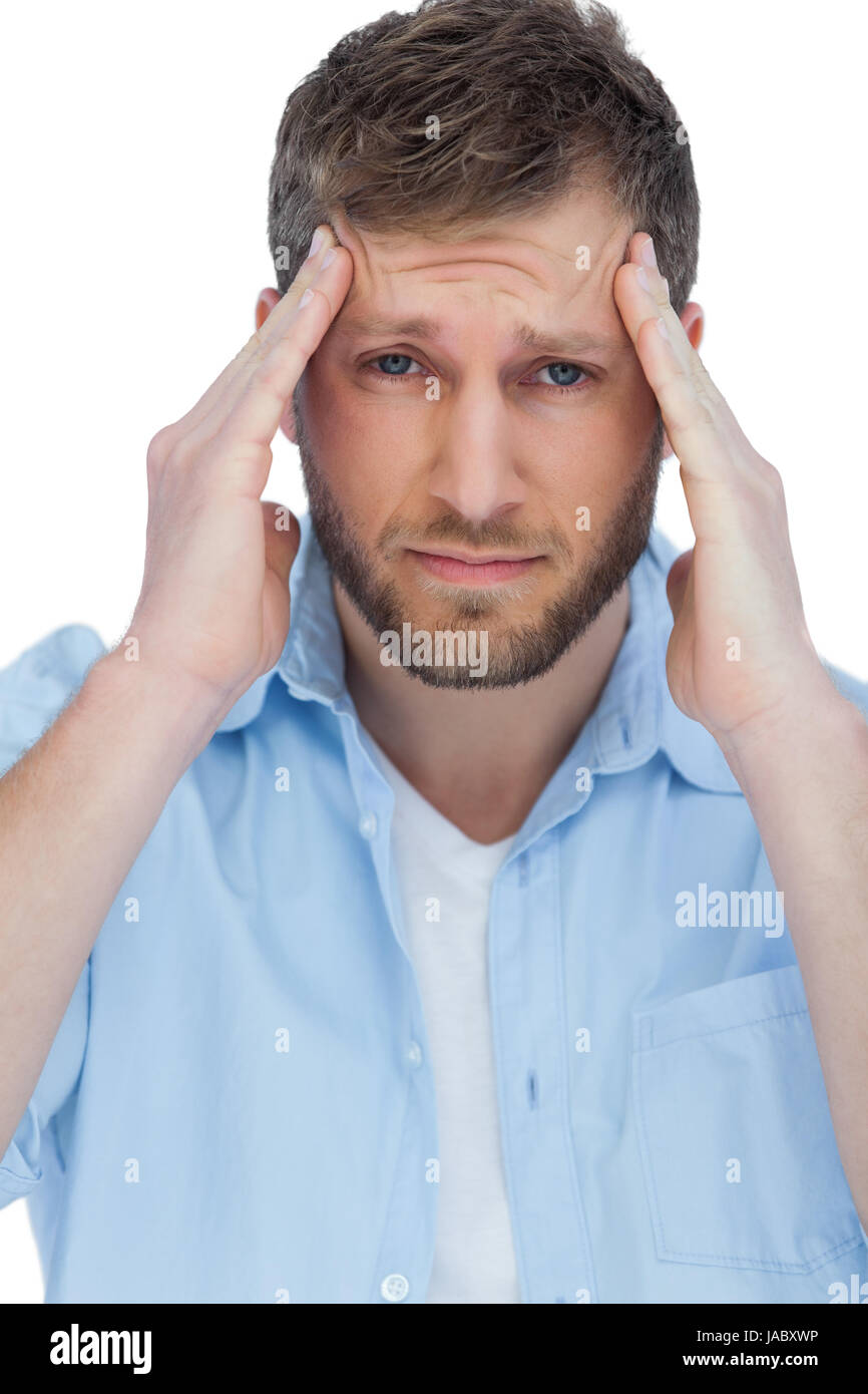 Handsome model having headache on white background Stock Photo - Alamy