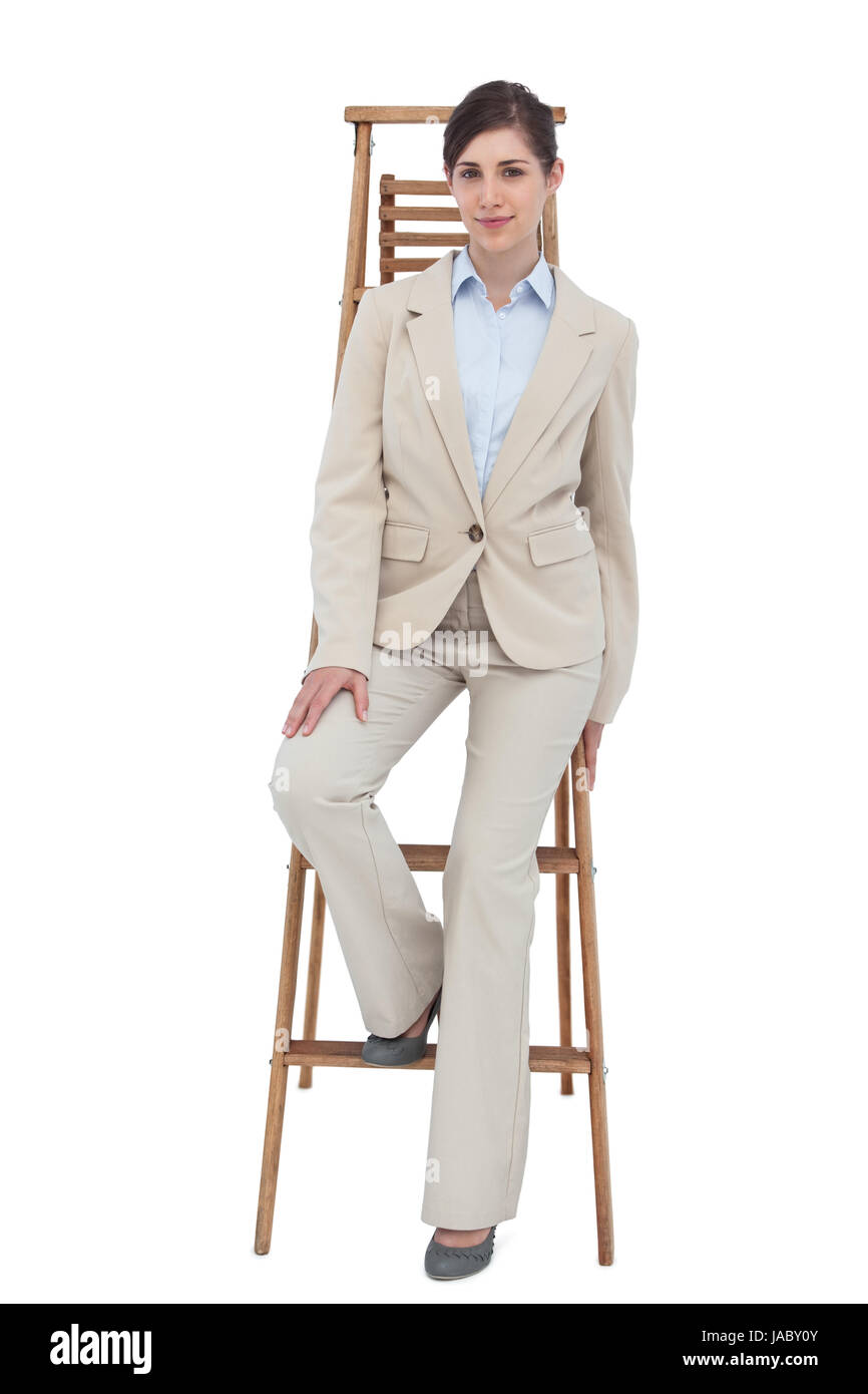 Young businesswoman sitting on career ladder on white background Stock ...