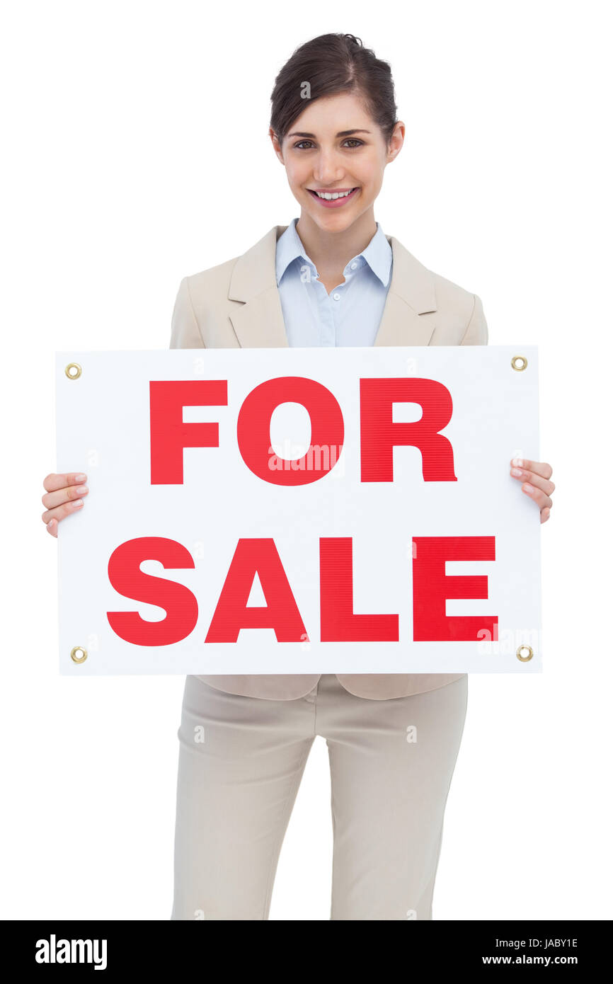 Smiling businesswoman with for sale sign on white background Stock ...