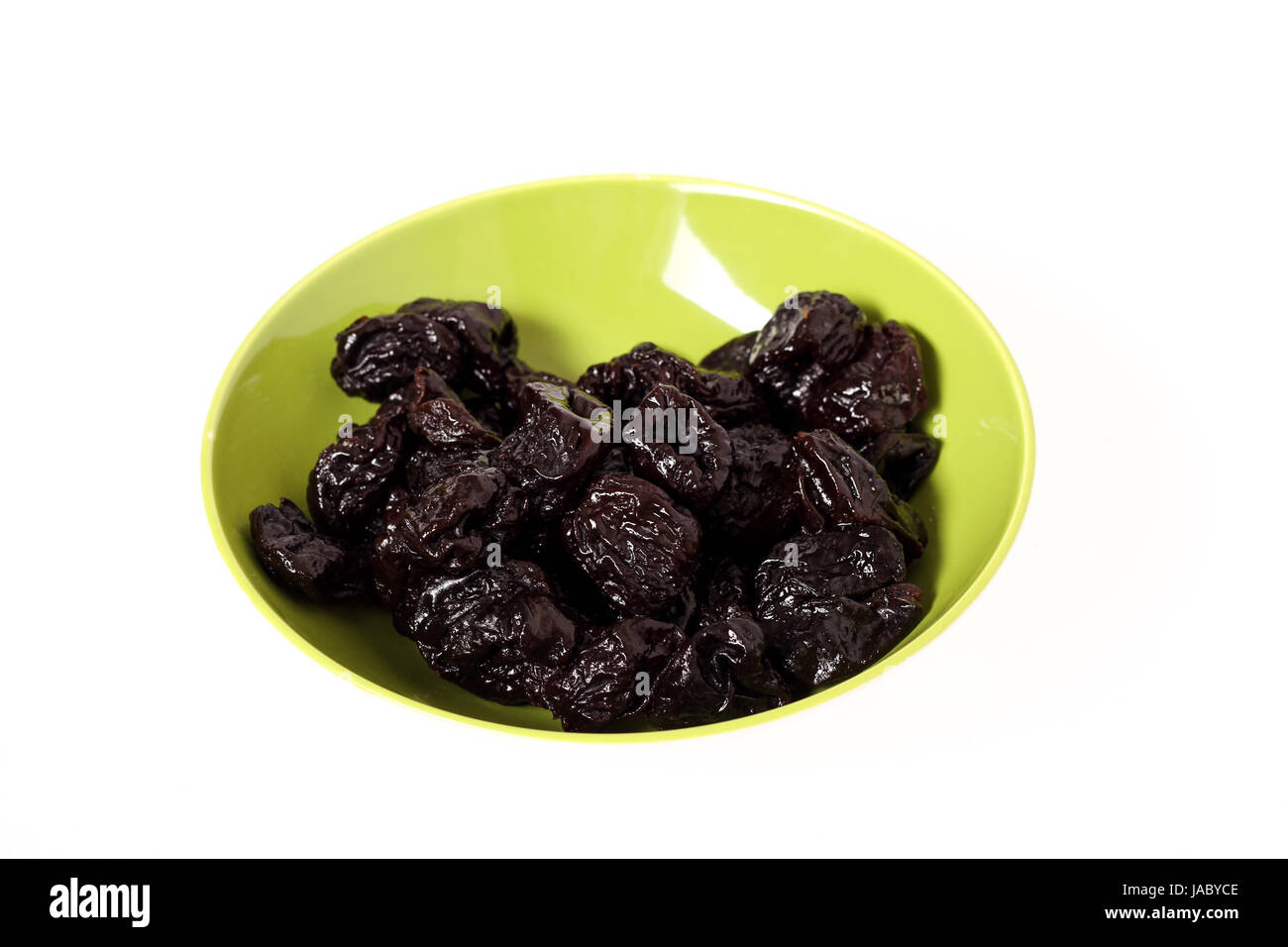 A pile of prunes on a bowl, isolated Stock Photo - Alamy