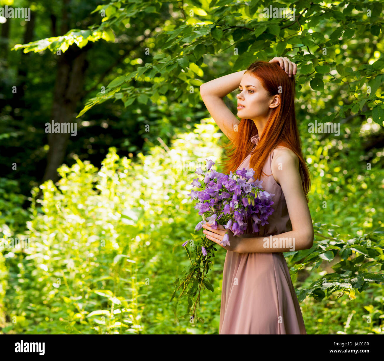 beautiful young girl in spring forest with flowers Stock Photo - Alamy