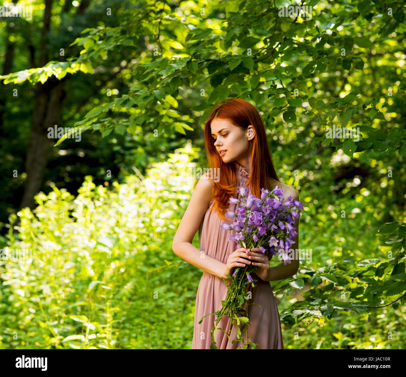 young girl in spring forest with flowers Stock Photo - Alamy