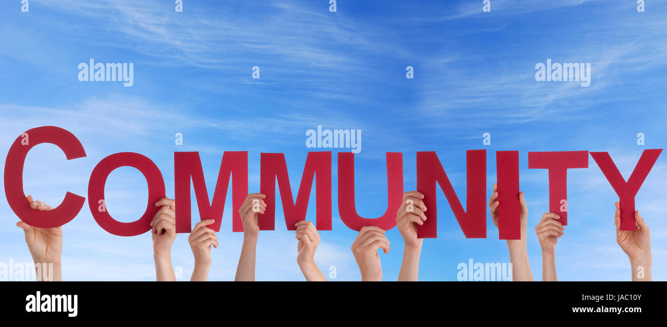 Many People Holding the Red Word Community in the Sky Stock Photo - Alamy