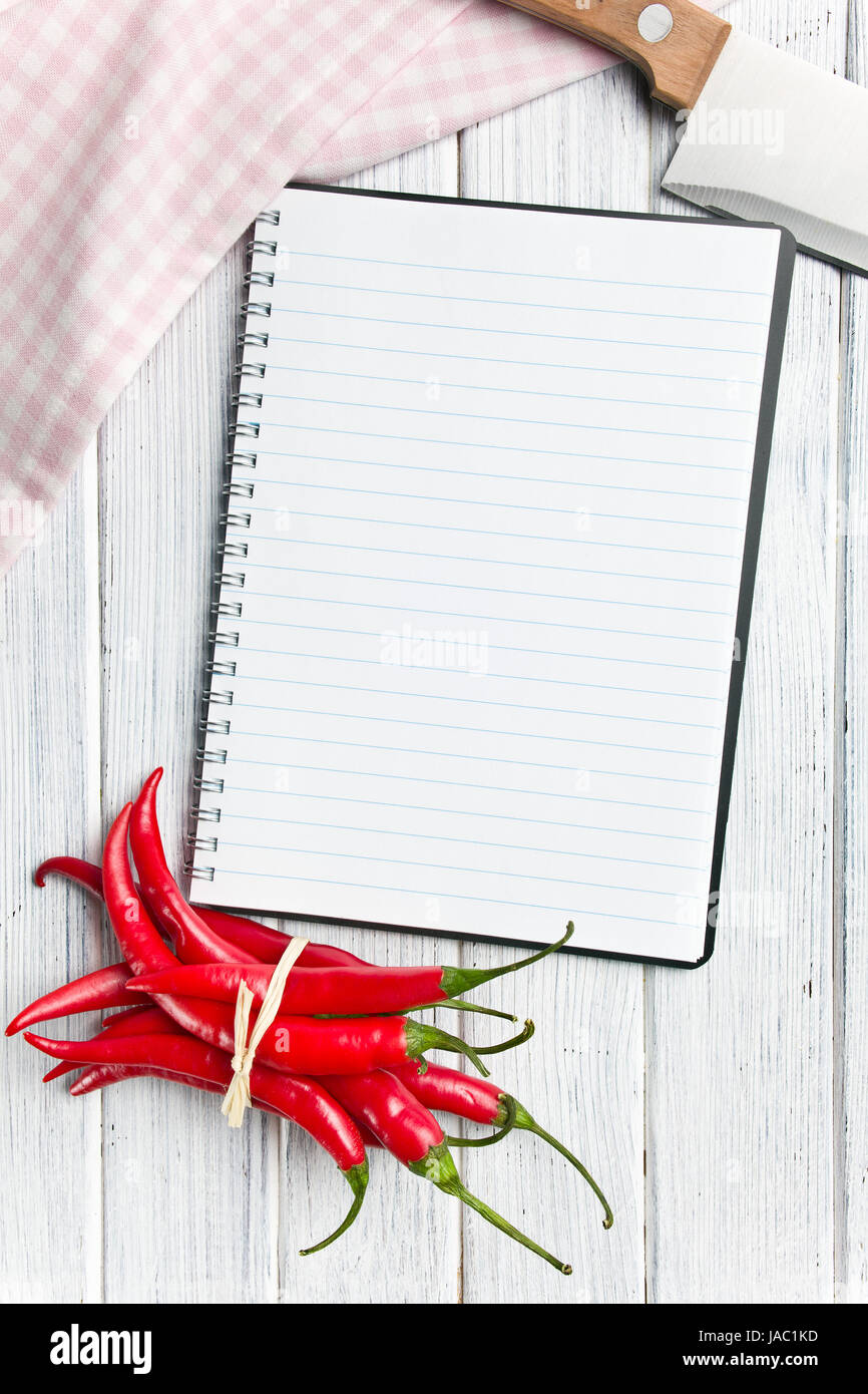 top view of recipe book with chili peppers Stock Photo - Alamy