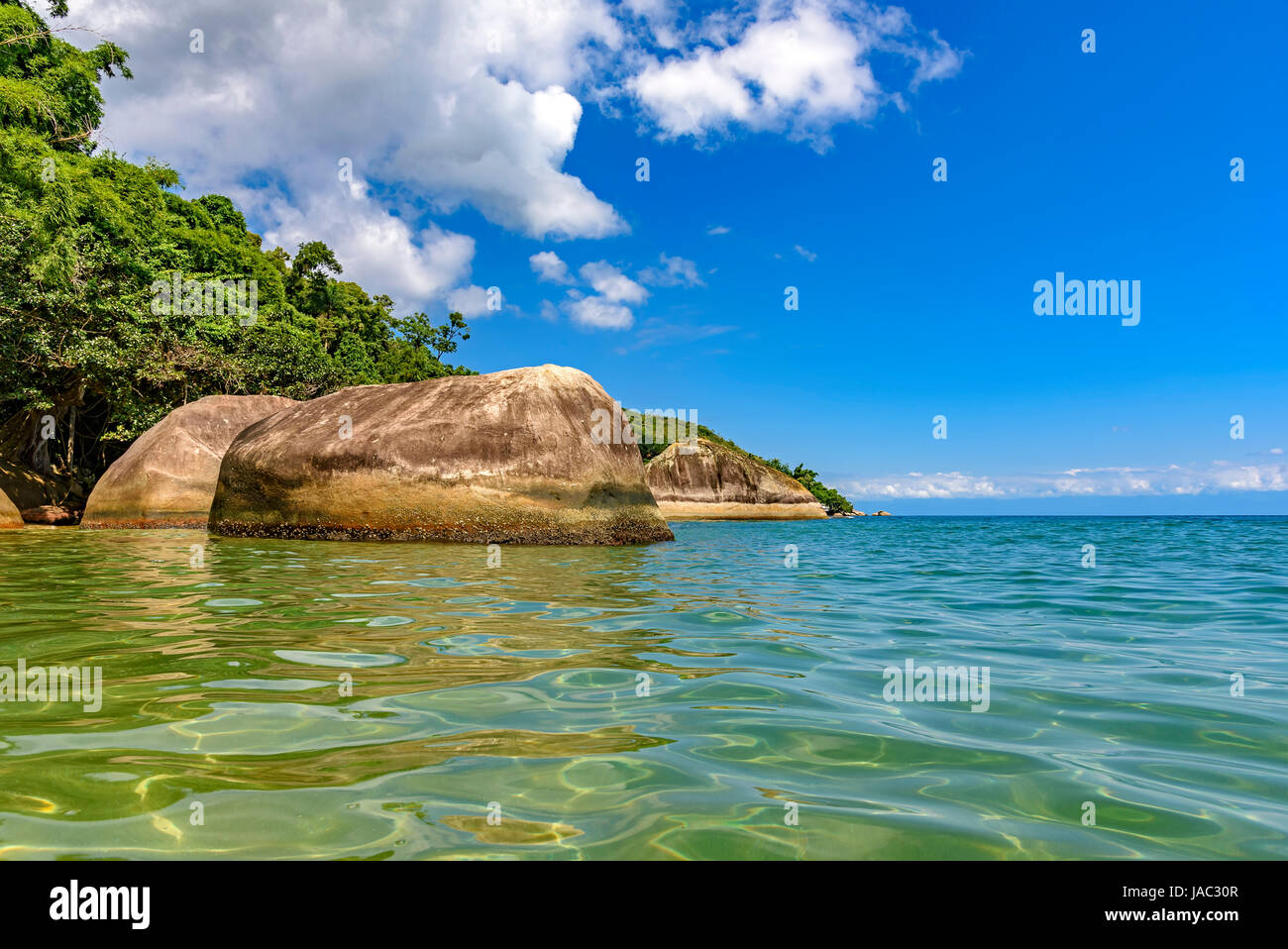Deserted and unspoilt beach with its limpid and transparent waters that ...