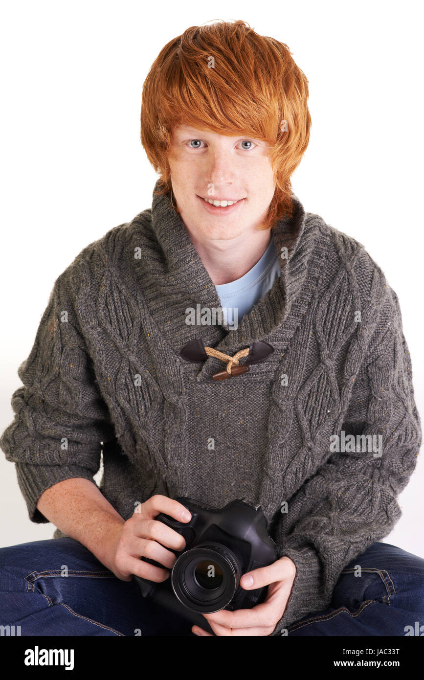 Portrait Of Attractive Redhead Guy With Photo Camera Looking At Camera