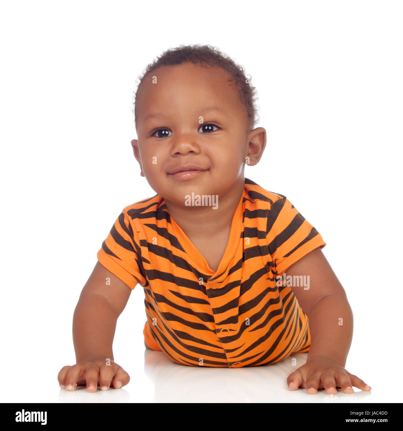 Adorable african baby lying on the floor isolated on a white background ...