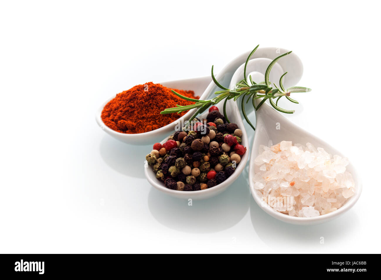 Himalayan rock salt, red cayenne pepper and black peppercorns in ...