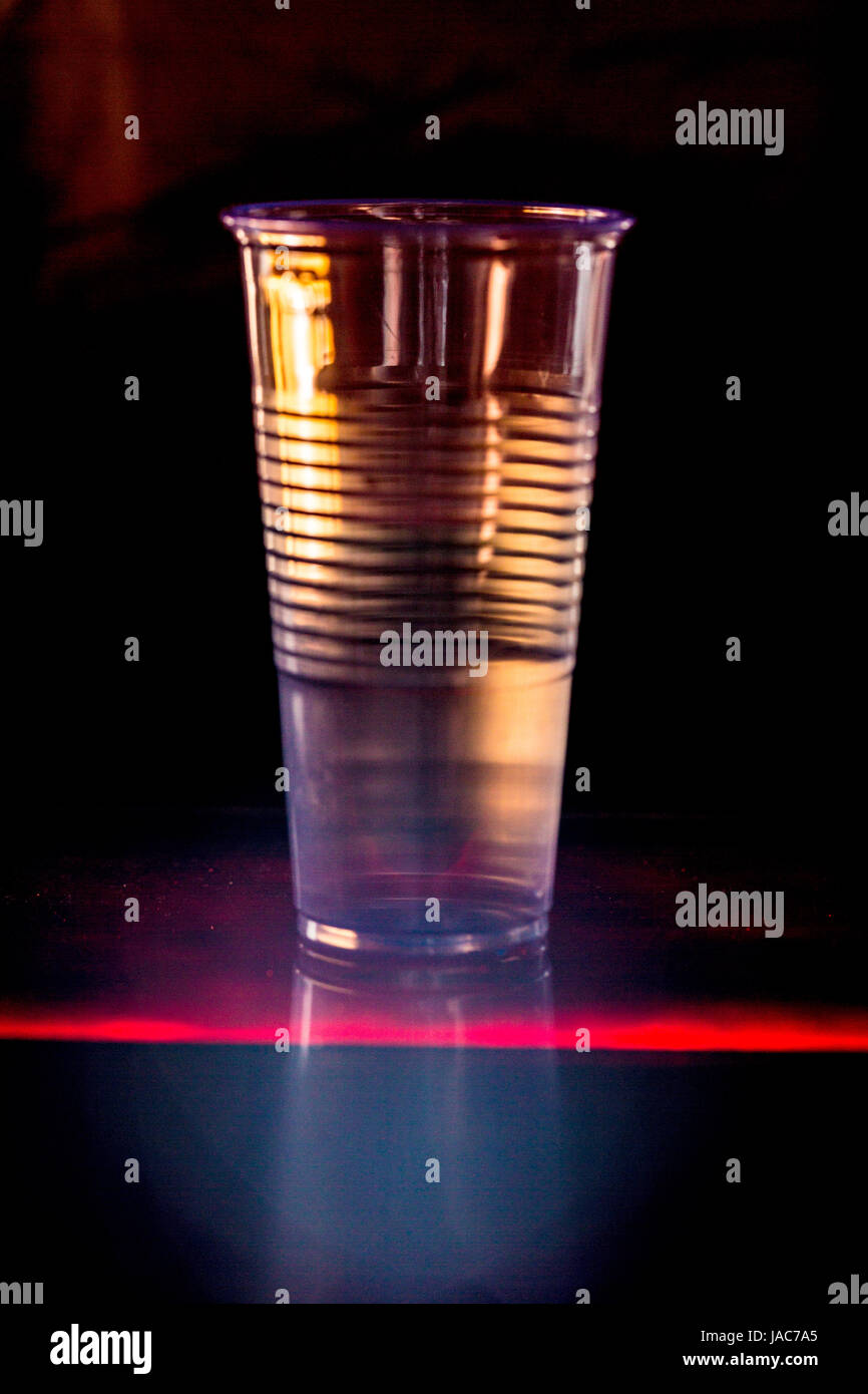 plastic cup on the glass table Stock Photo - Alamy