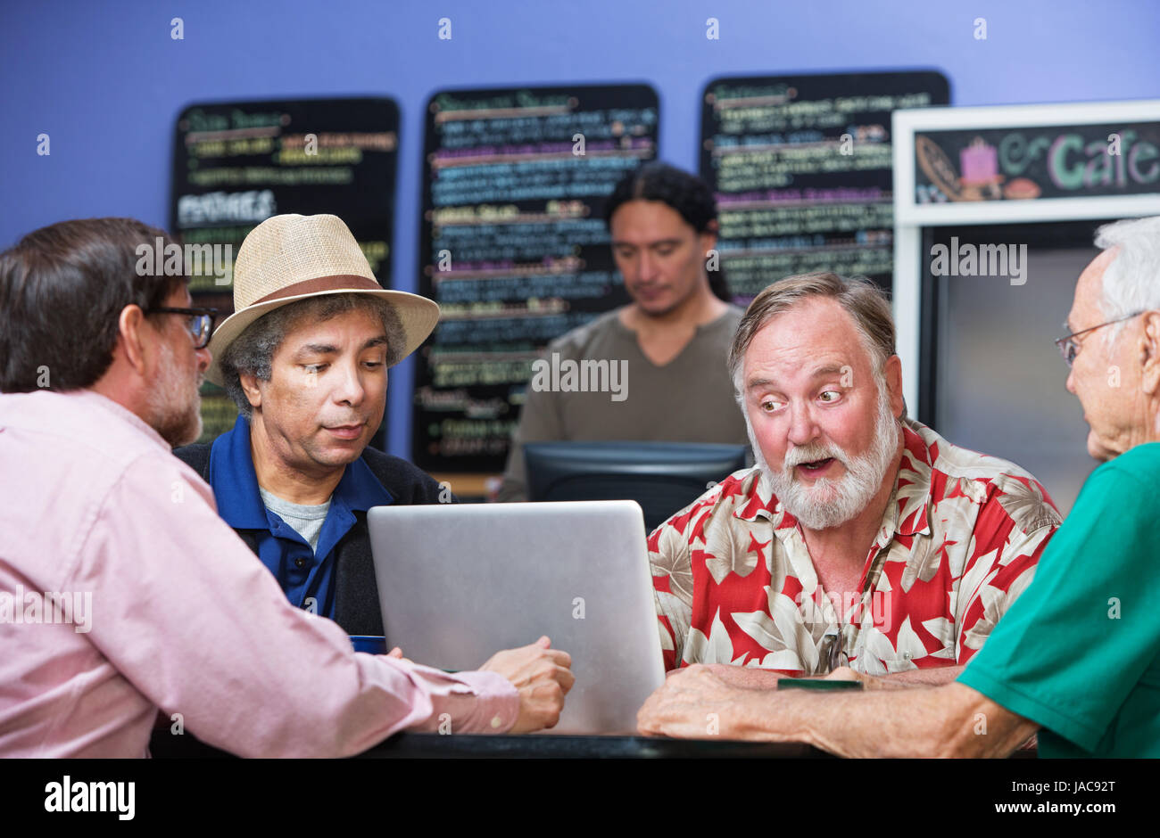 Four serious mature men in cafe with laptop Stock Photo - Alamy
