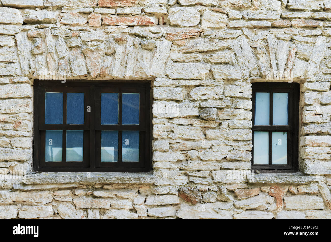 Two Closed Window In The Stone Wall Stock Photo - Alamy