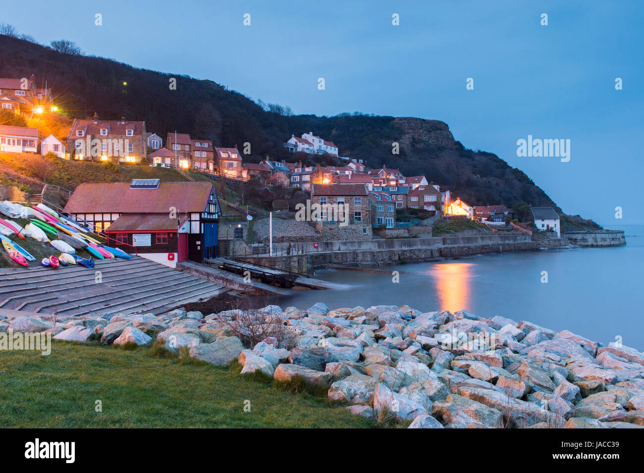 Lights are lit in houses in evening view of pretty quaint coastal ...