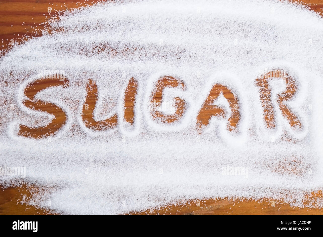 The word sugar written into a pile of white granulated sugar Stock ...