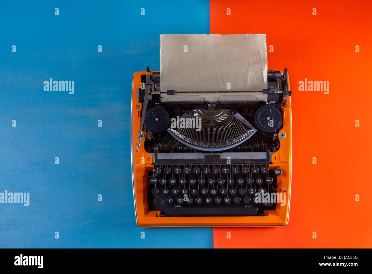 Workspace with vintage orange typewriter Stock Photo - Alamy