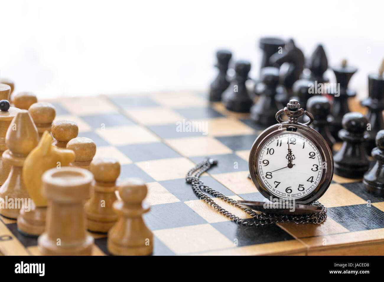 Vintage pocket watch and chess pieces on chess board Stock Photo - Alamy